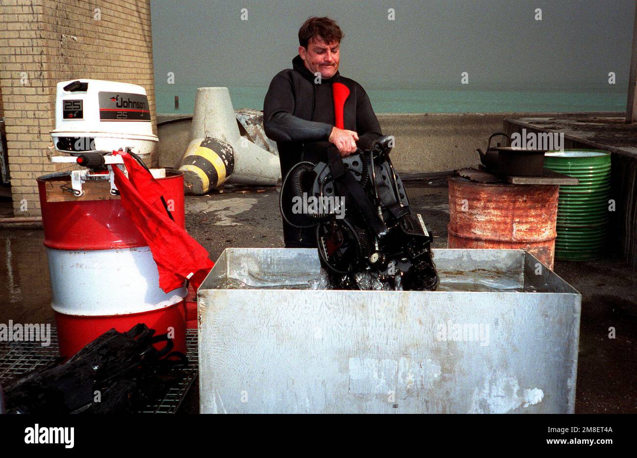 A U.S. Navy explosive ordnance disposal (EOD) team member rinses his ...