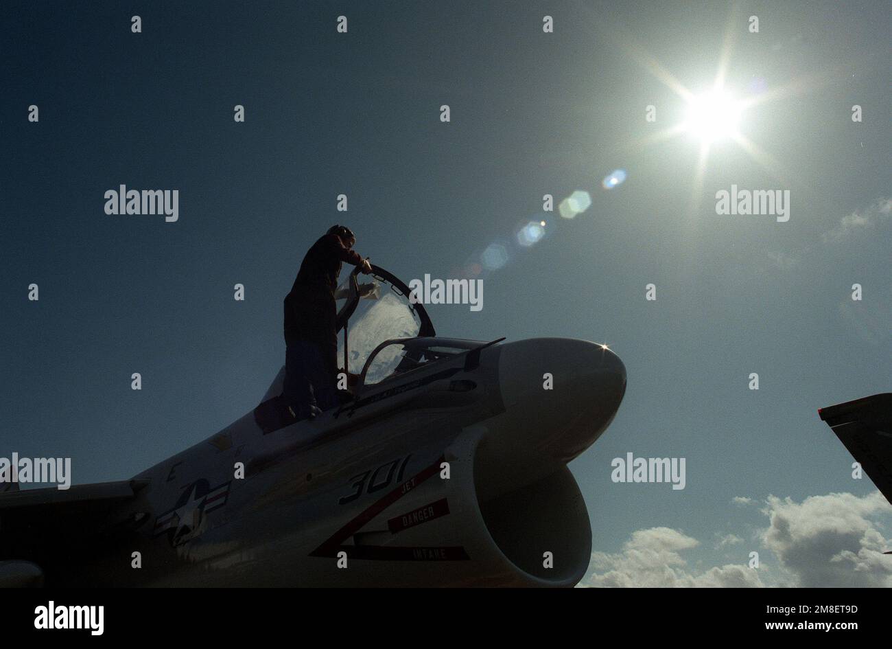 A maintenance crewman from Attack Squadron 46 (VA-46) polishes the ...