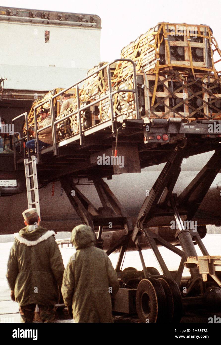 A K-loader positions crates of 155mm propellant canisters for loading ...