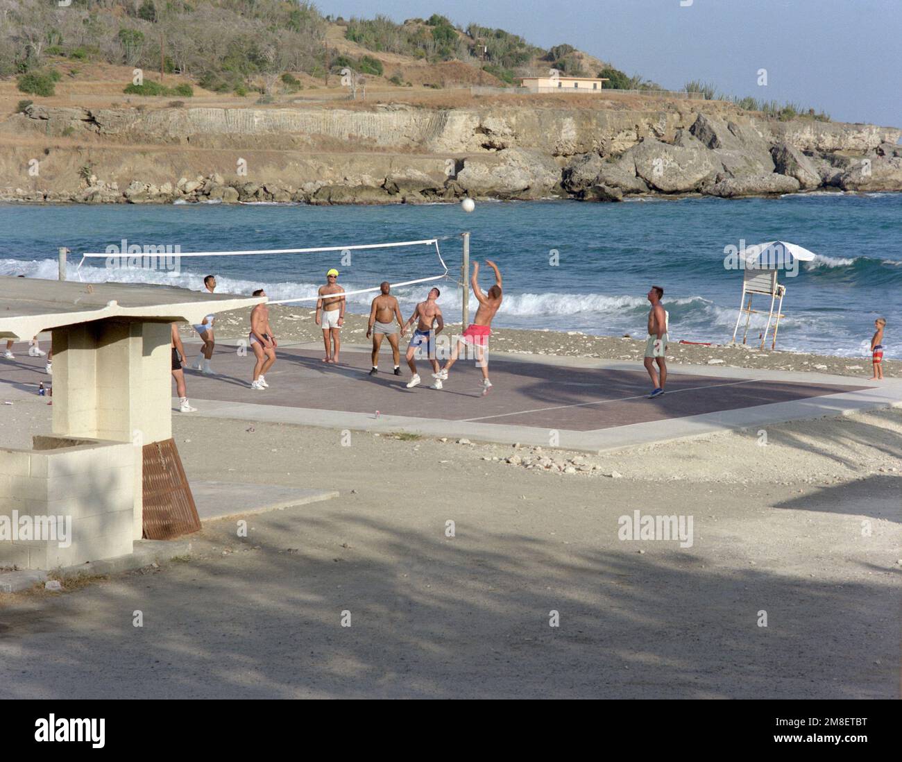 Off-duty servicemen play volleyball at Windmill Beach. Exact Date Shot ...