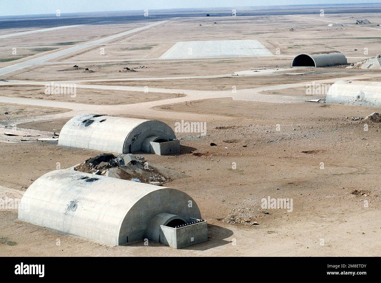 A view of damage to hardened aircraft shelters at Al-Salman Air Base ...