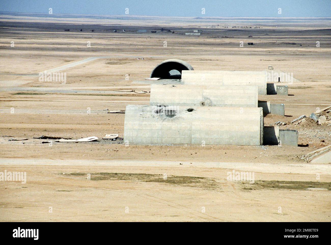A view of damage to hardened aircraft shelters at Al-Salman Air Base ...