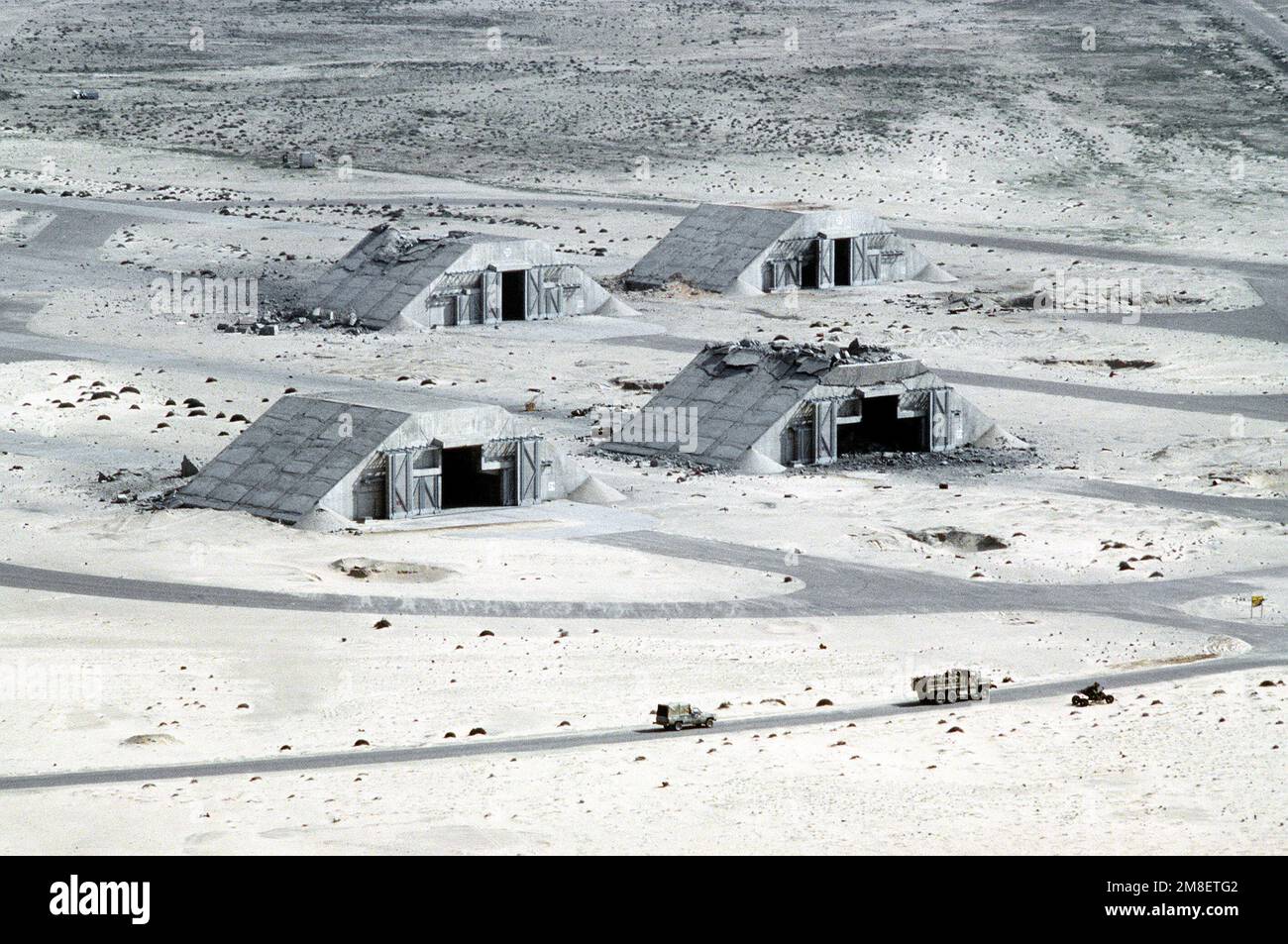 Iraqi hardened aircraft shelters damaged by Allied air strikes stand in ...