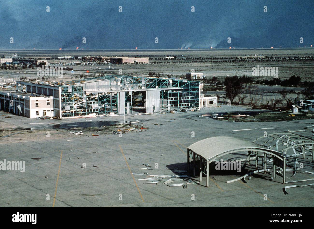 A view of a destroyed hangar building at Kuwait International Airport ...