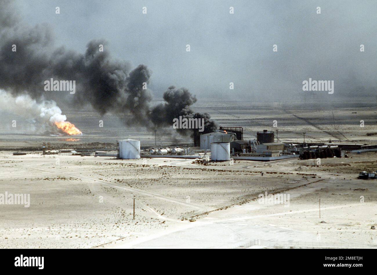Oil wells burn out of control, darkening the sky with smoke, after ...