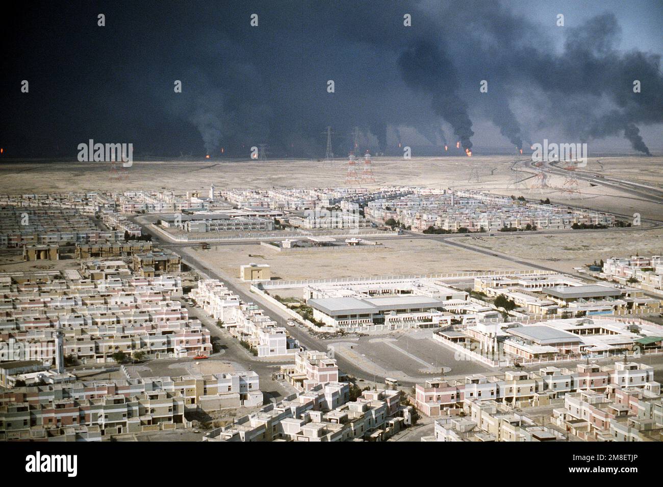 Oil wells burn out of control, darkening the sky with smoke, after ...