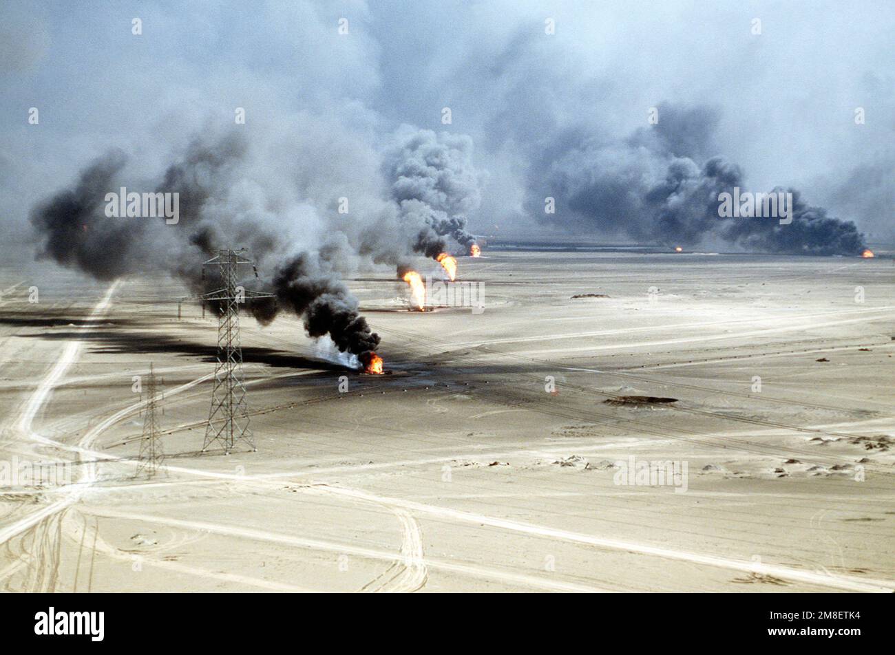 Oil wells burn out of control, darkening the sky with smoke, after being set ablaze by ...
