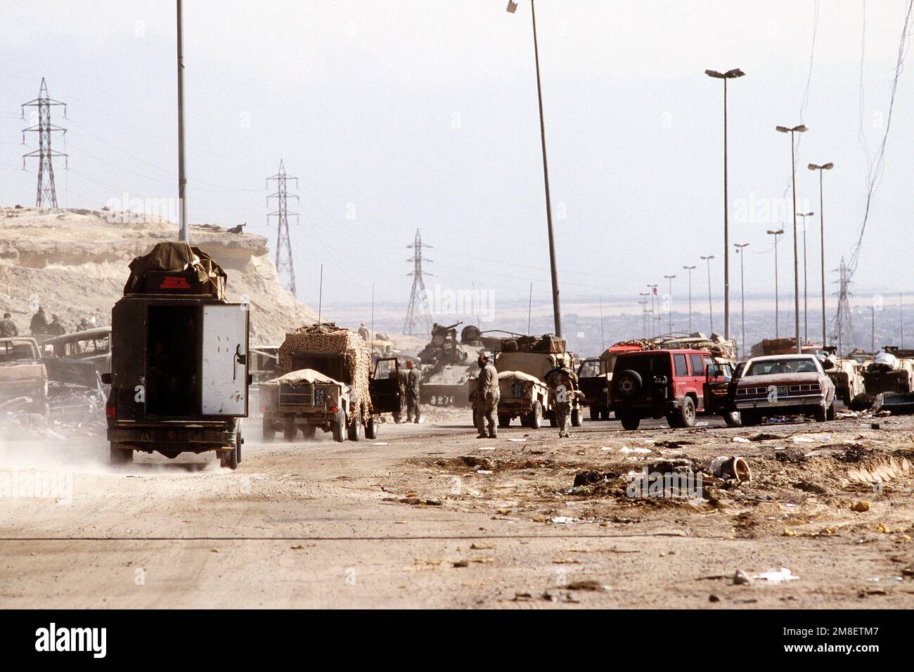 U.S. military vehicles move along Al Mutla Pass, north of Kuwait City ...