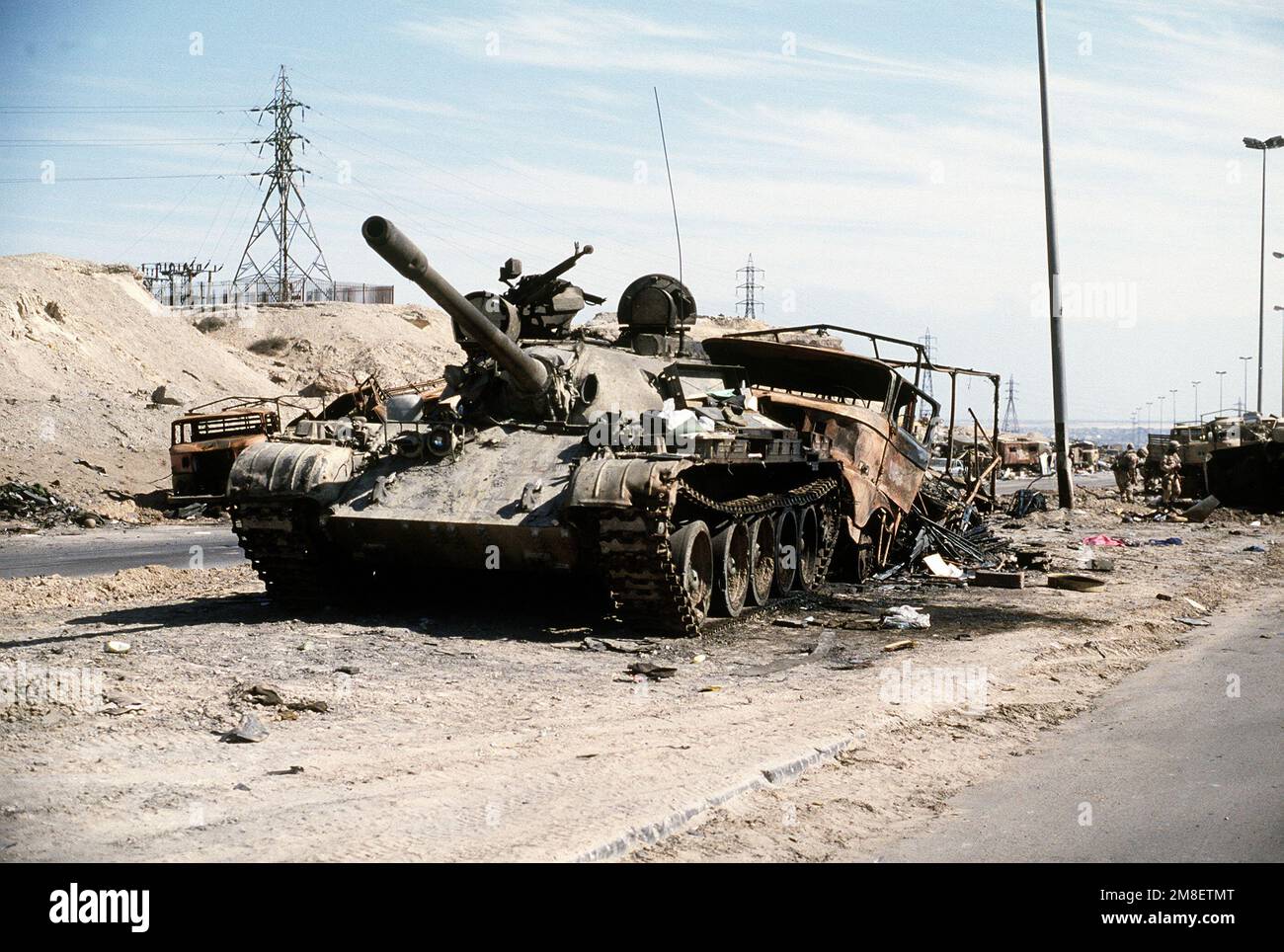 A T-55 main battle tank and other demolished Iraqi equipment litter Al ...