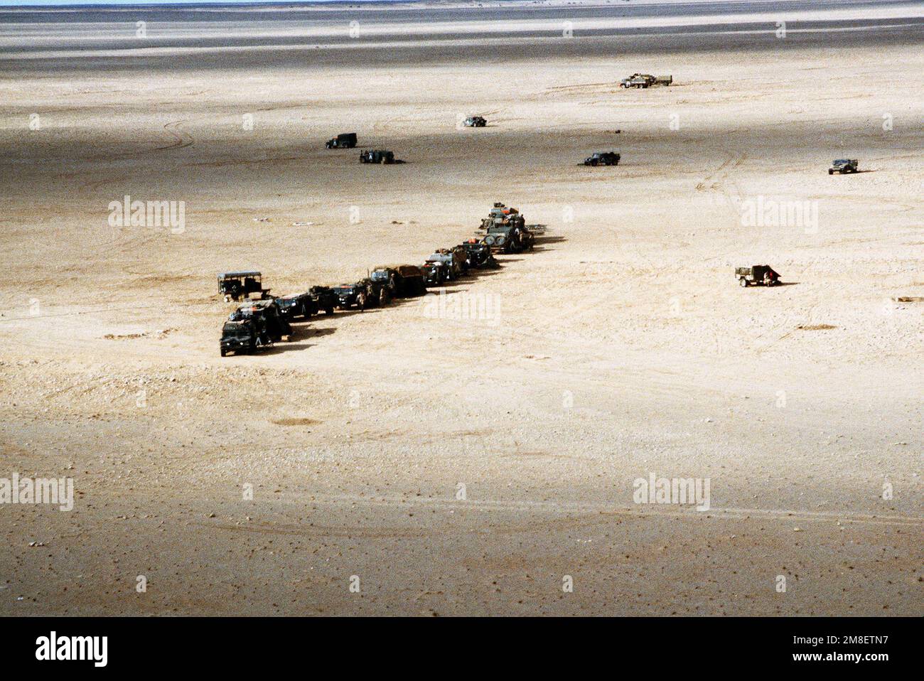 A convoy of U.S. military vehicles arrives at a staging area during ...
