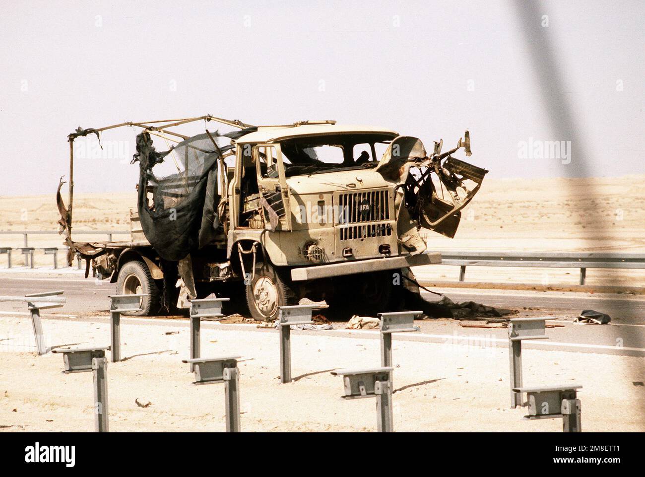 A demolished truck stands on a roadway after being destroyed in an ...