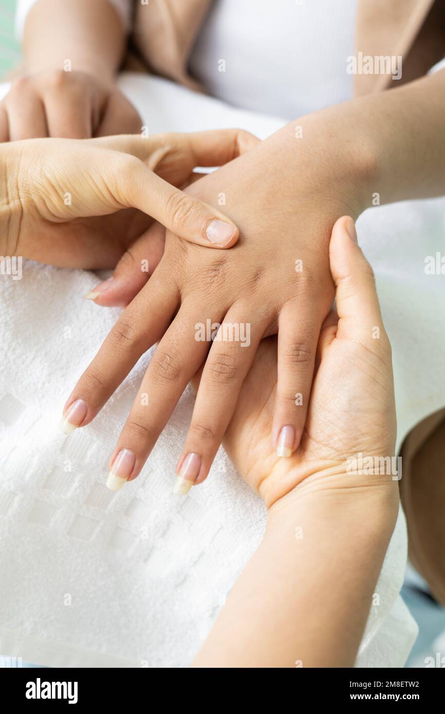 healthcare professional doing hand massage, spa beauty treatment ...