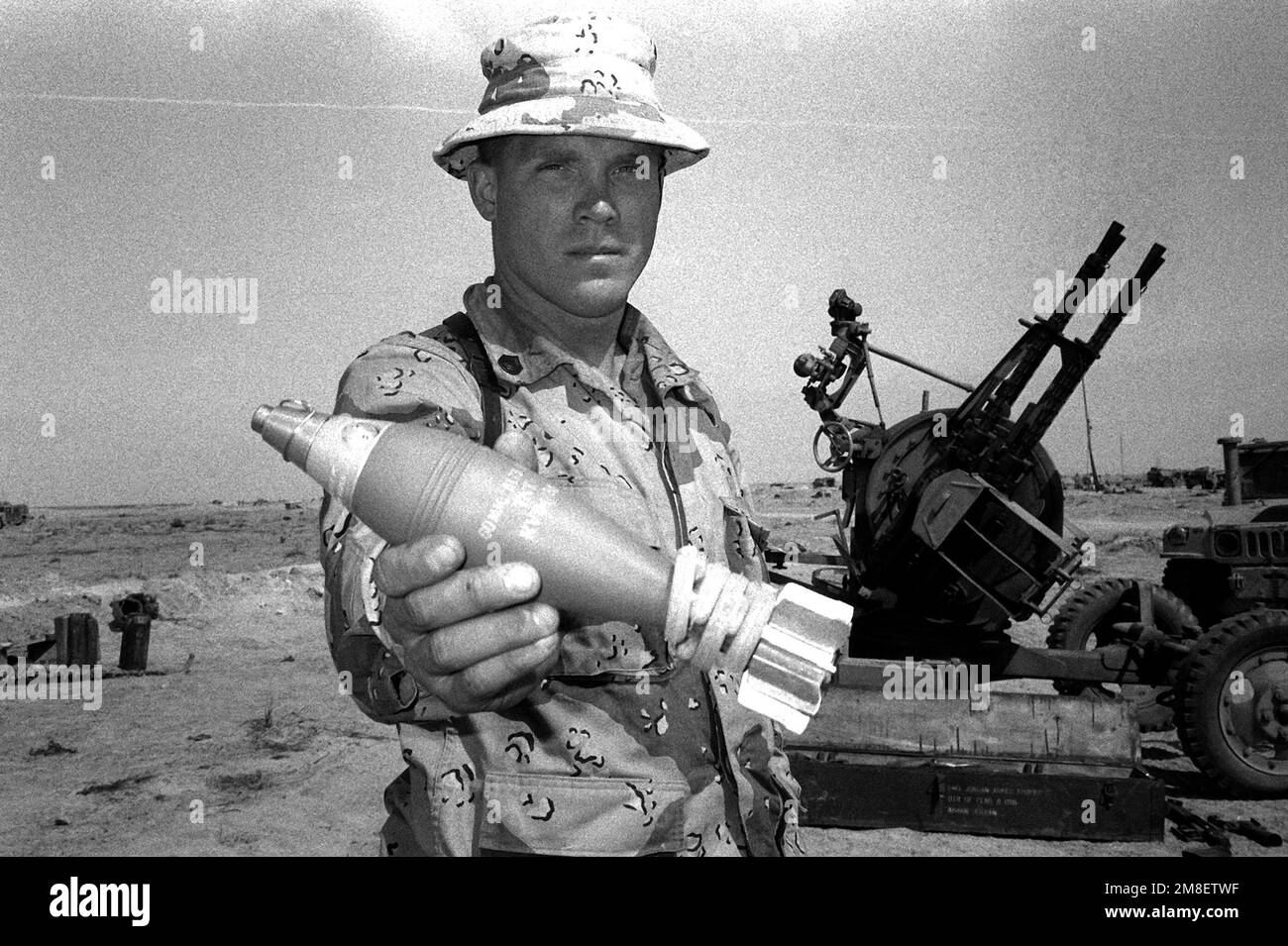 STAFF SGT. Lance D. Wilson holds a 60mm mortar round, part of a display ...
