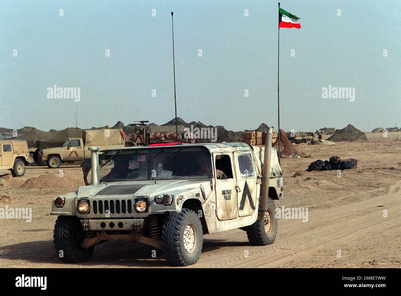 The Kuwaiti flag flies from an M-998 high-mobility multipurpose wheeled ...