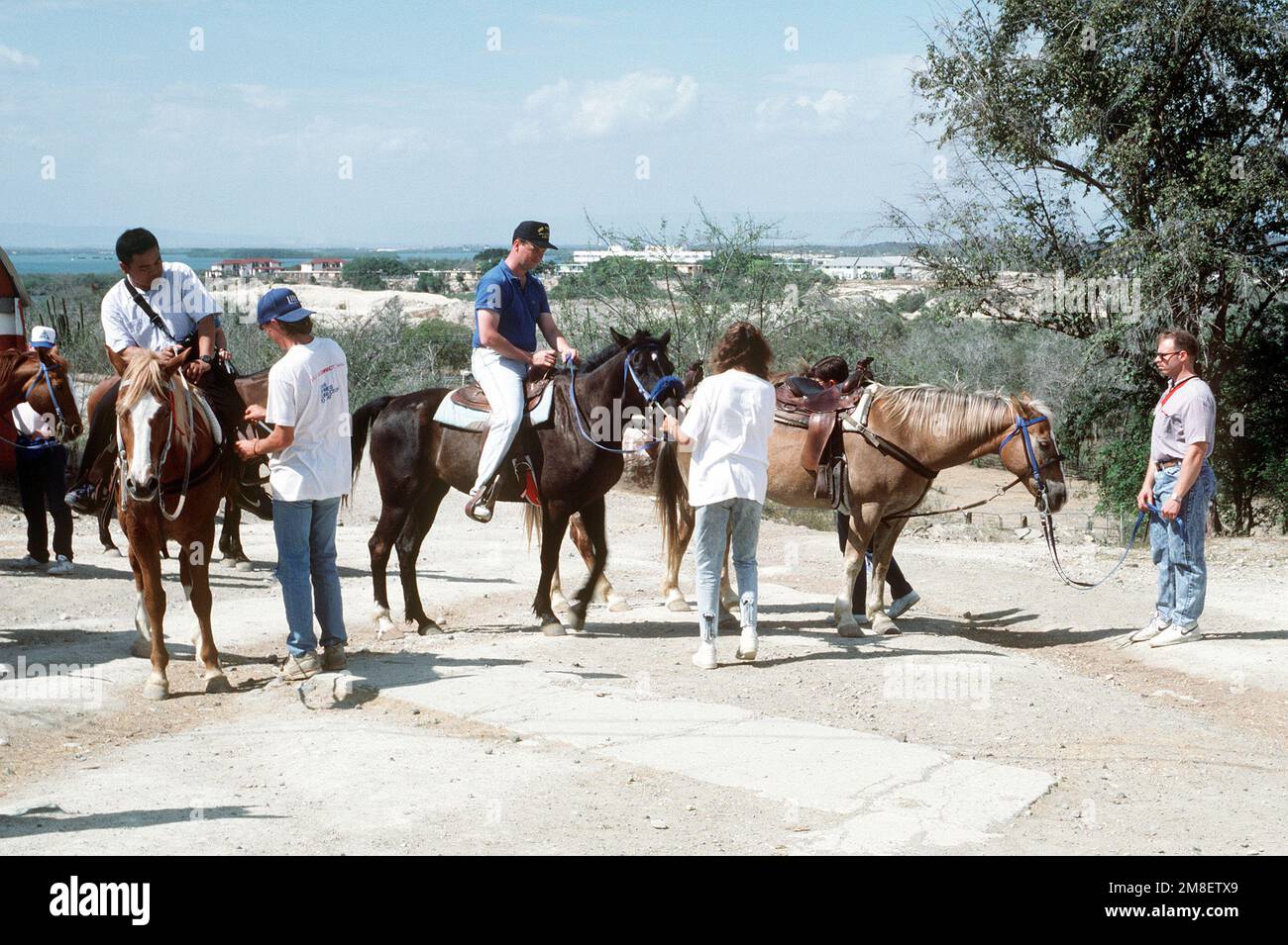 Sailors from visiting ships climb aboard their rented horses with the ...
