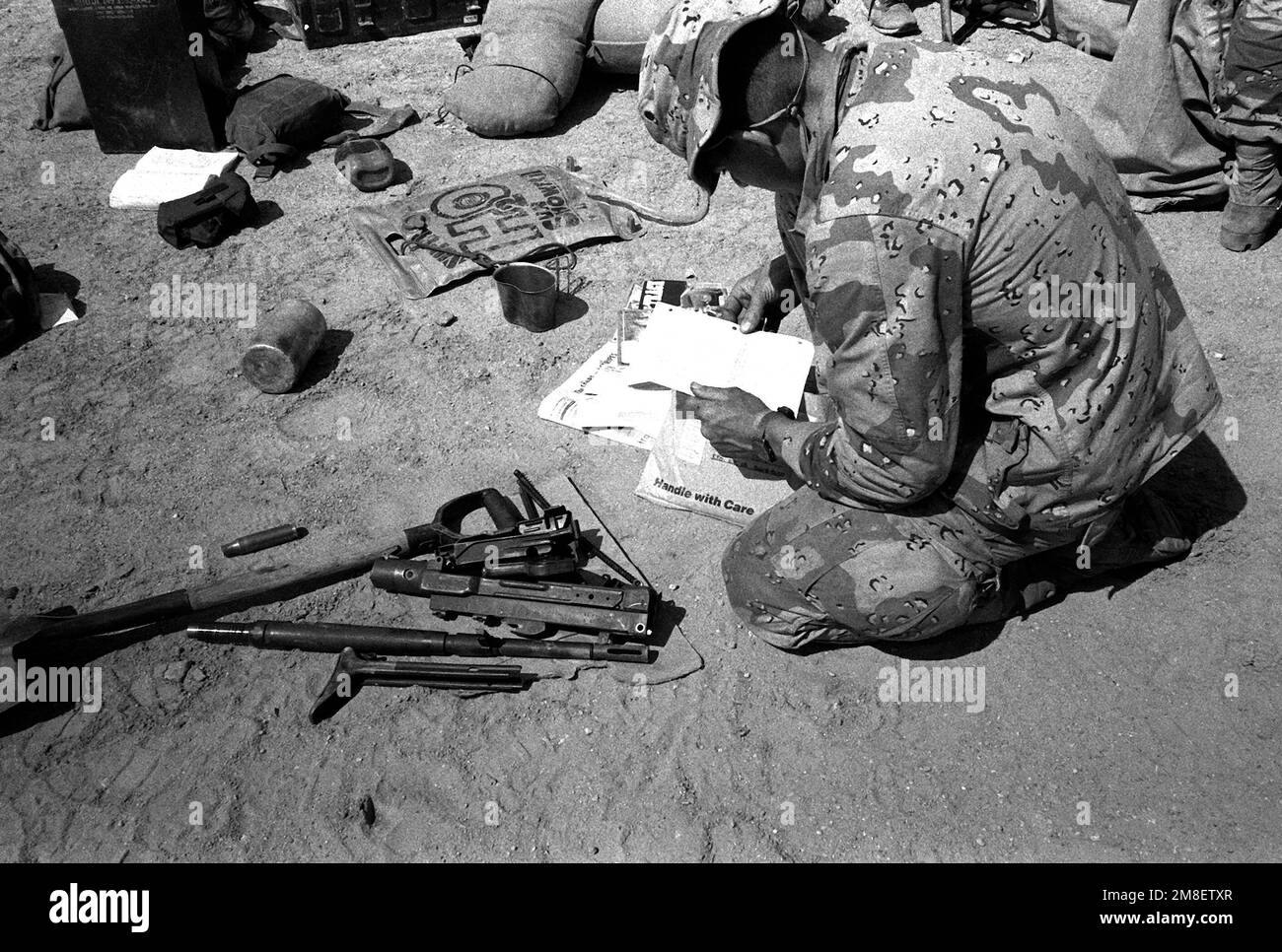 First LT. Timothy P. Harryman reads a letter during his unit's first ...