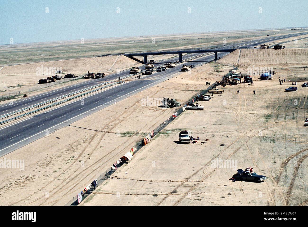 M-1A1 Abrams main battle tanks guard a U.S. checkpoint along Highway 8 ...
