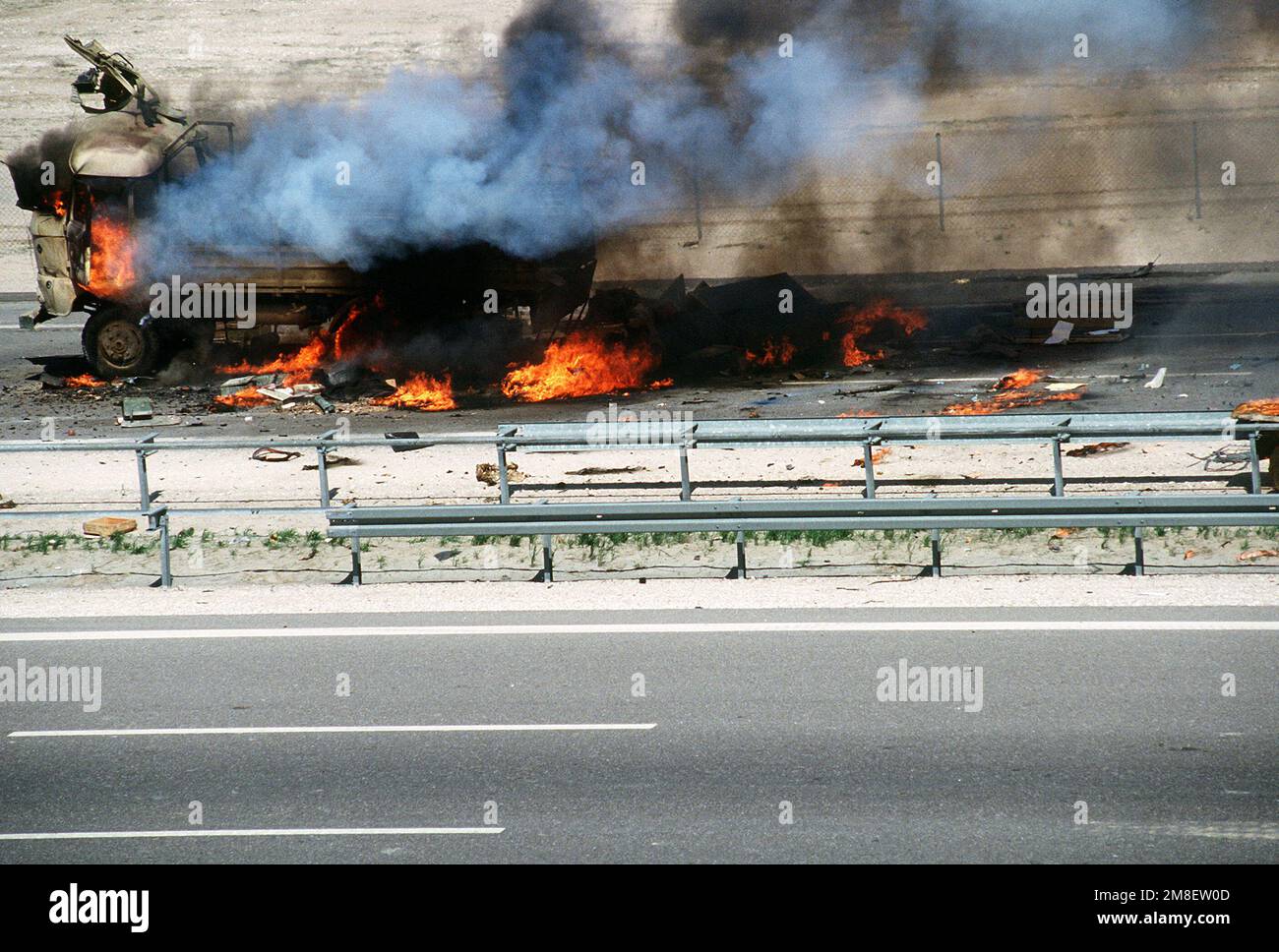 An Iraqi truck burns on Highway B as a result of Allied bombing during ...