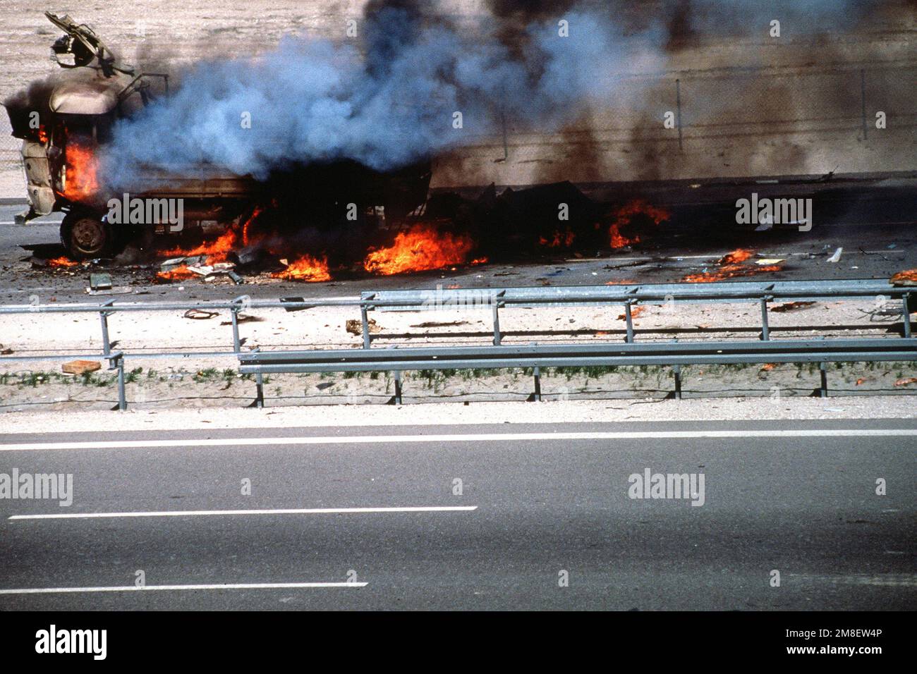 An Iraqi supply truck burns on a highway after being hit in a Coalition ...