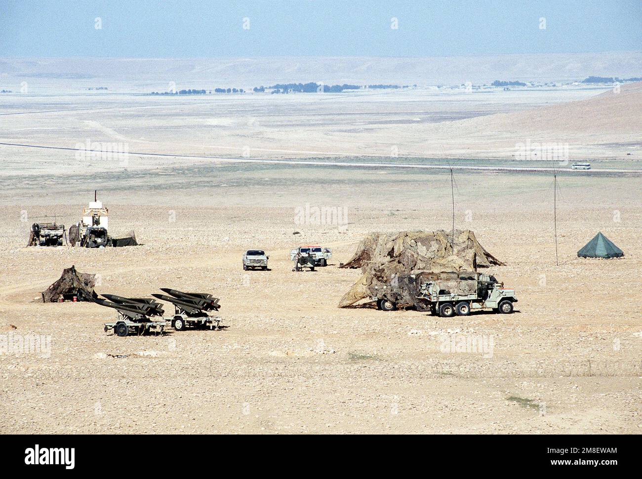 A U.S. Hawk surface-to-air missile battery stands ready outside Al ...