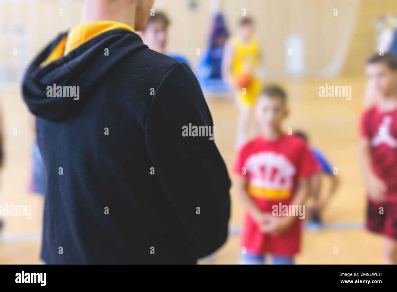 Junior young basketball team with a coach, group of kids children team ...