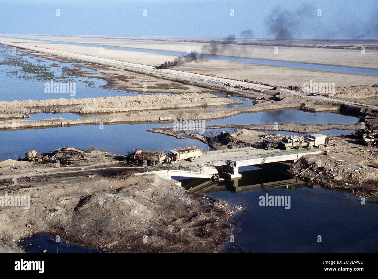 A view of a partially collapsed bridge and abandoned and demolished ...