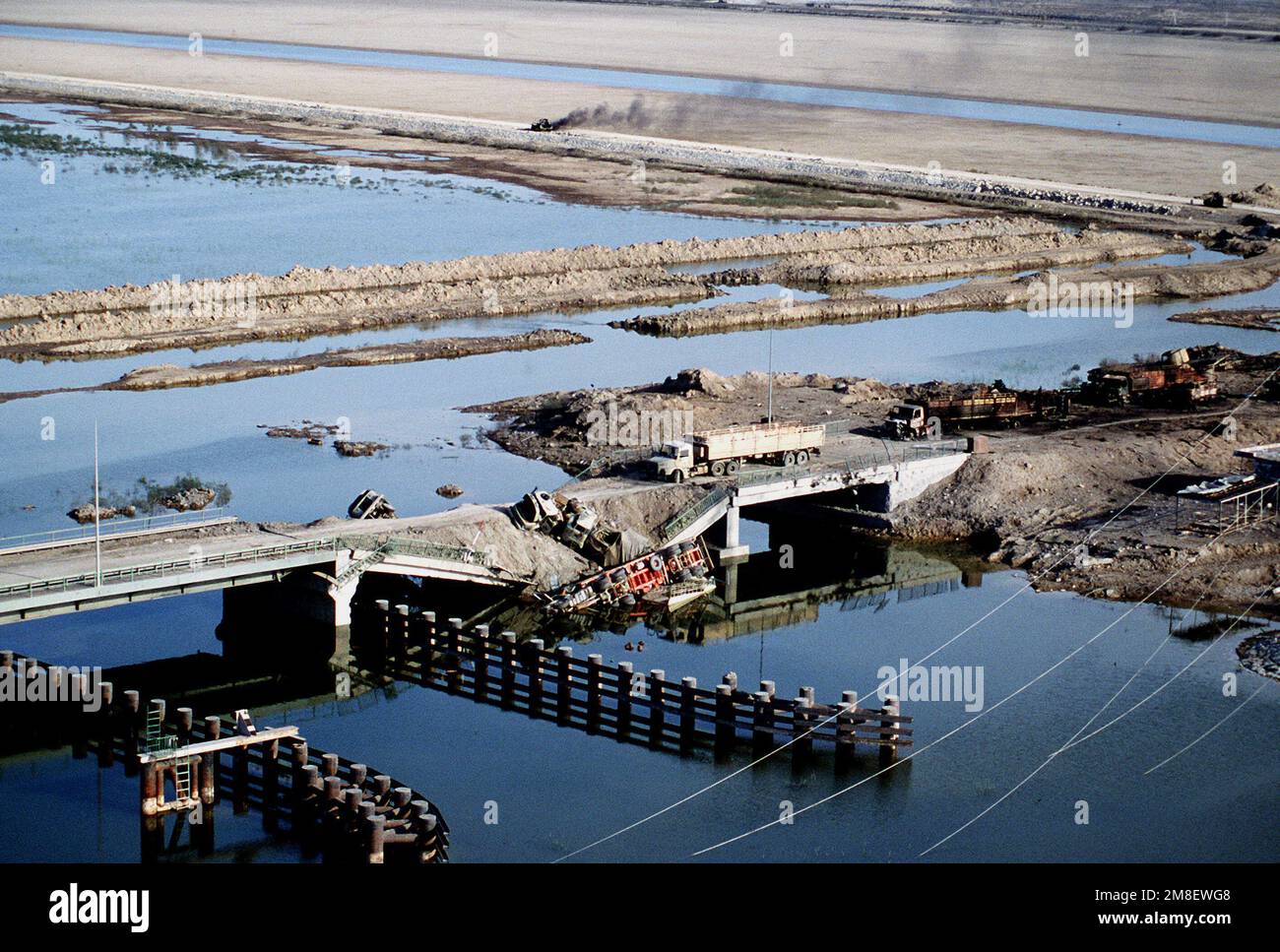 A bridge and several trucks destroyed in the Euphrates River Valley ...