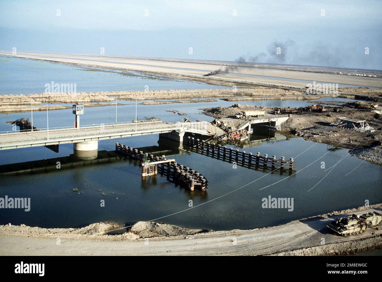 A bridge and several trucks destroyed in the Euphrates River Valley ...