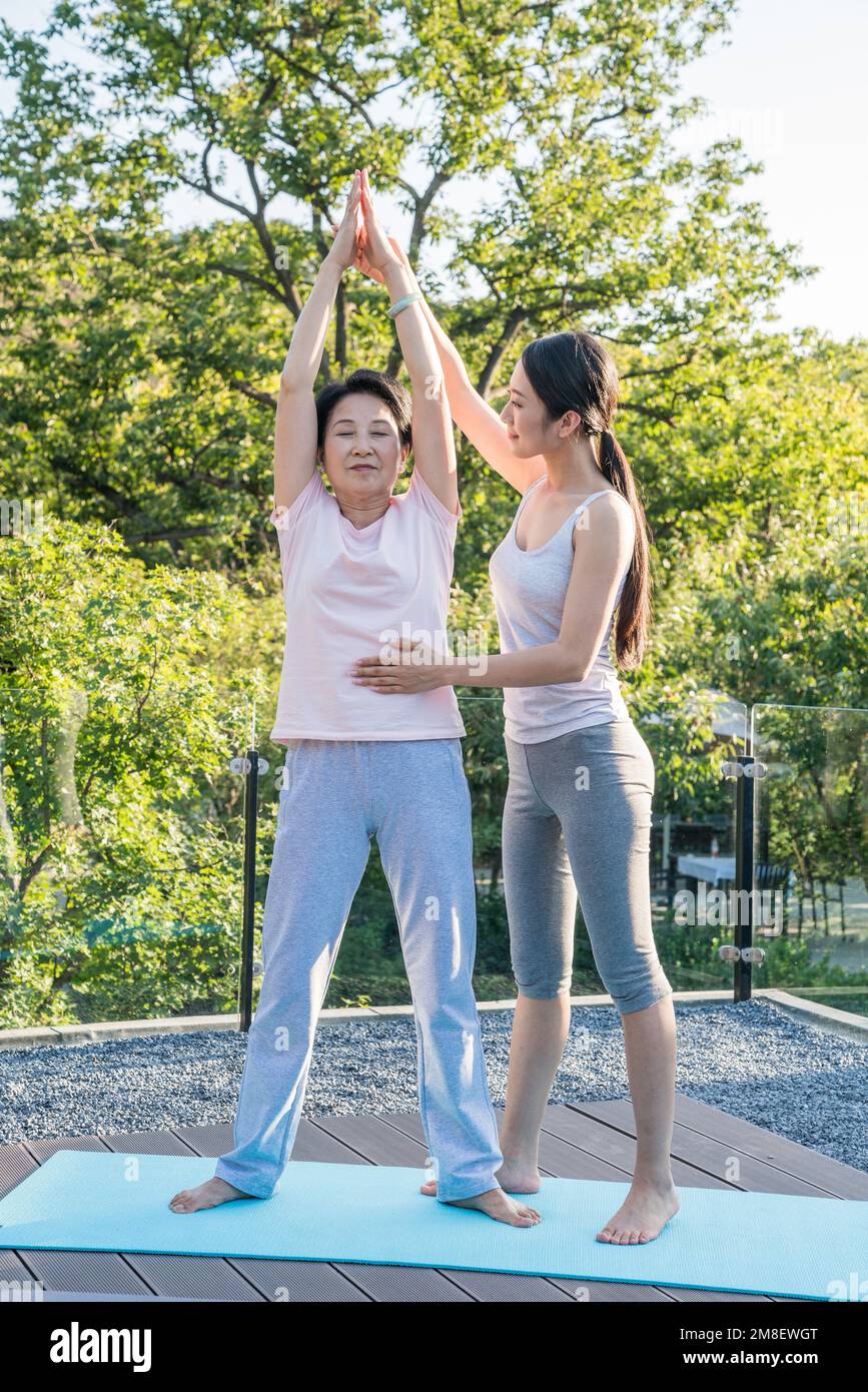 A young woman in guiding an exercise in the elderly Stock Photo - Alamy