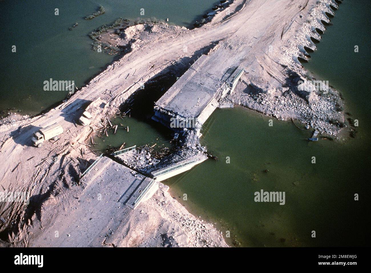 A view of a bridge in the Euphrates River Valley and Iraqi trucks ...