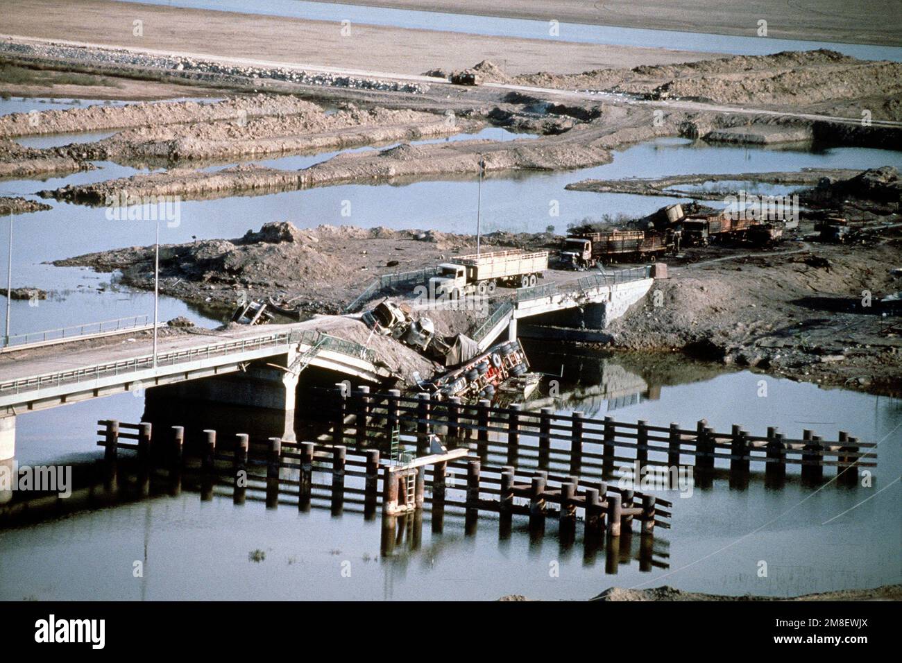 A view of a bridge in the Euphrates River Valley and Iraqi trucks ...