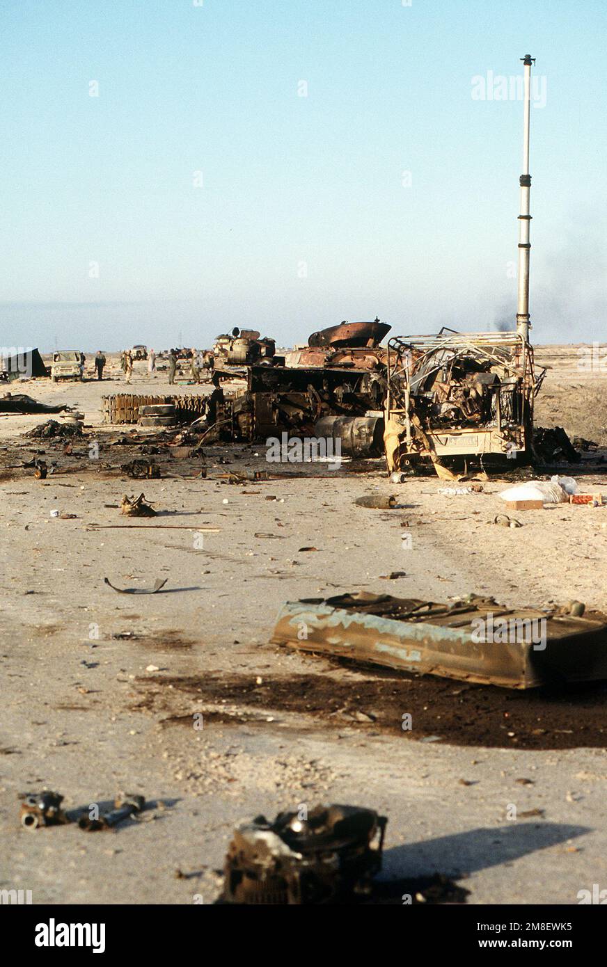 Demolished Iraqi vehicles line a roadway in the Euphrates River Valley ...