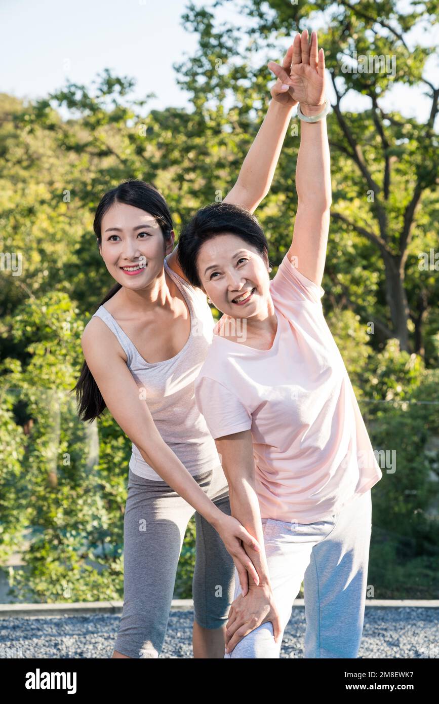 A young woman in guiding an exercise in the elderly Stock Photo - Alamy