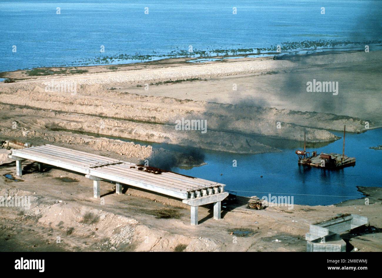 A section of unfinished highway partially obscures a group of Iraqi ...