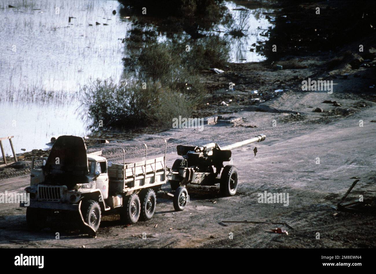 An Iraqi M-46 130mm howitzer behind a Ural-375D truck abandoned in the ...