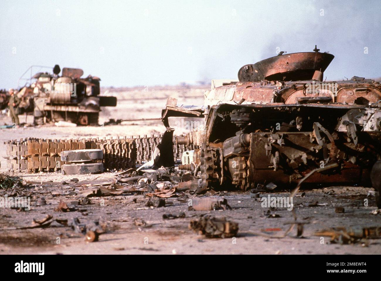 A demolished Iraqi BMP-1 infantry fighting vehicle and demolished tank ...