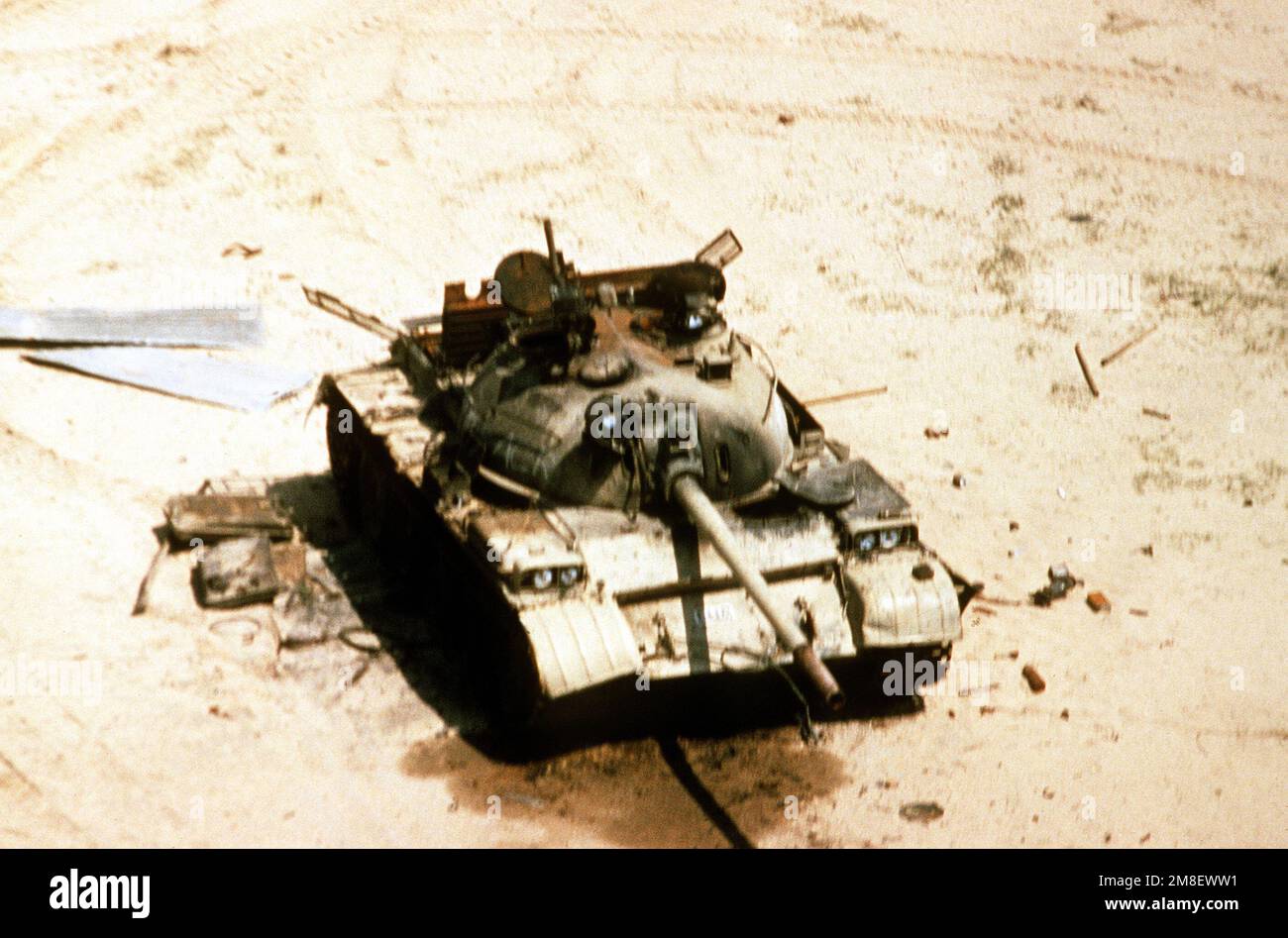 A demolished Iraq T-55 main battle tank sits in the sand after being ...