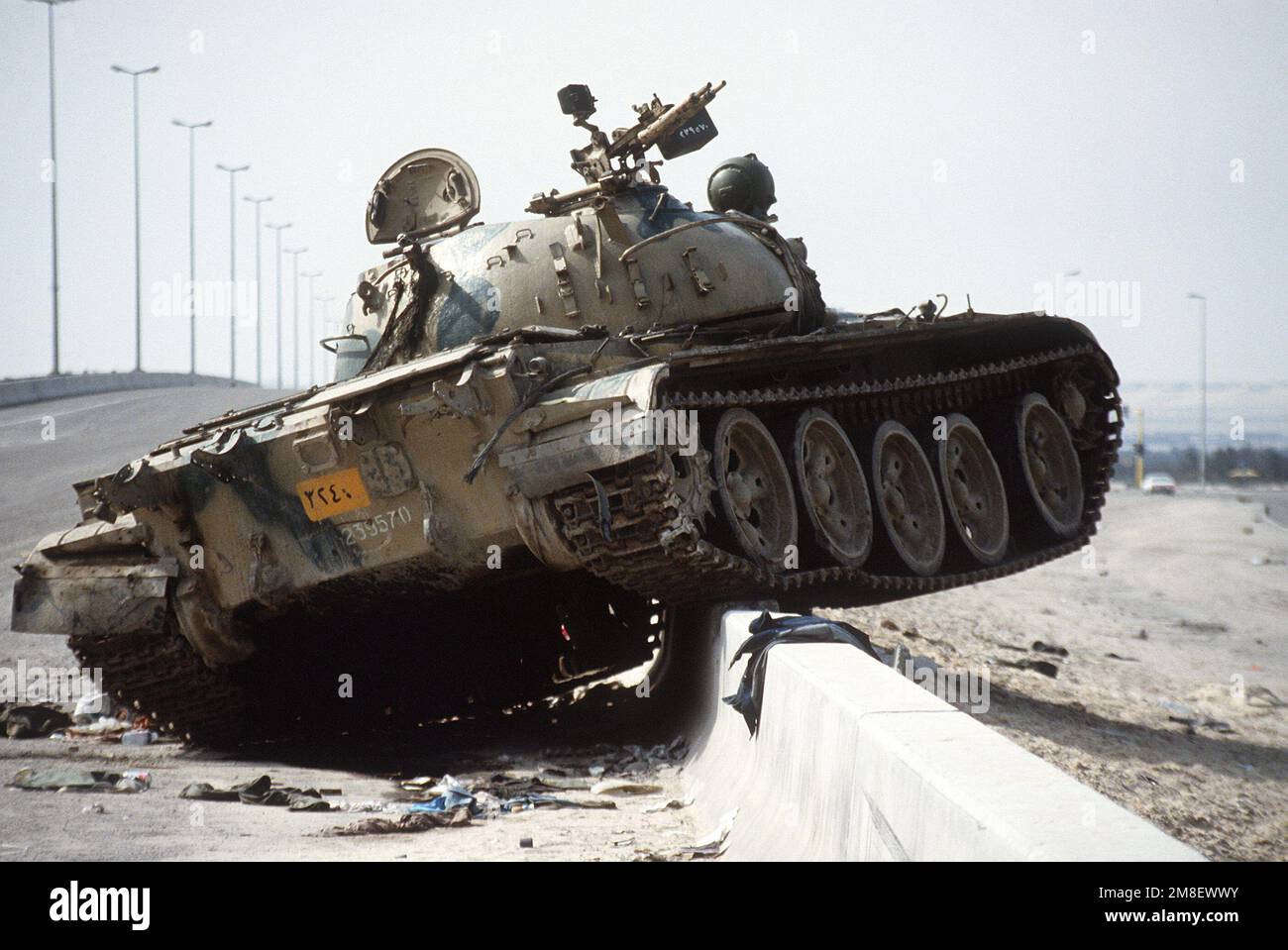A destroyed Iraqi T-55 main battle tank lies along the Basra-Kuwait ...