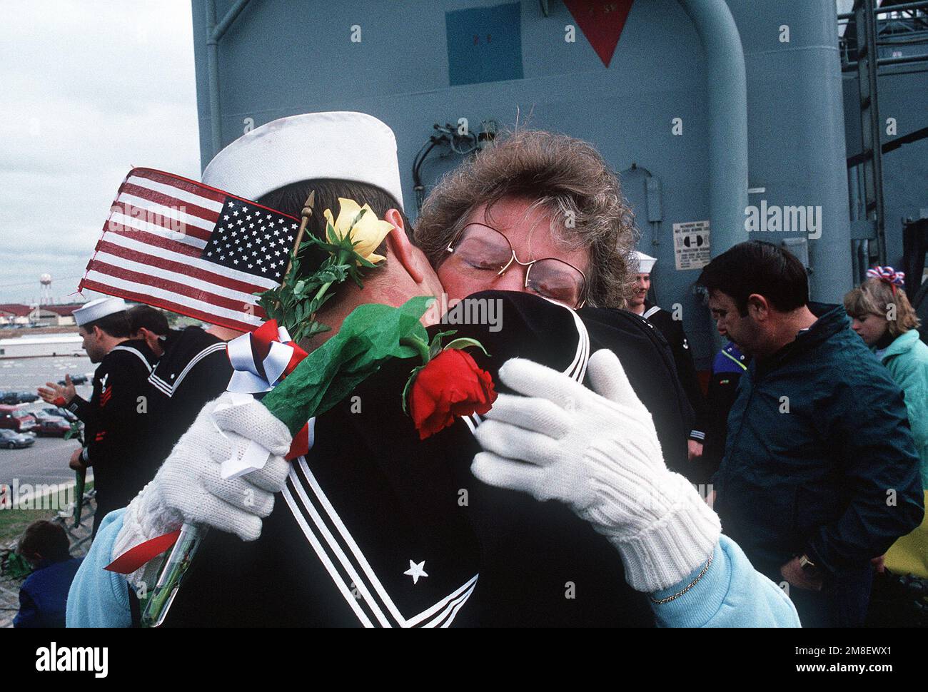 A sailor assigned to the amphibious assault ship USS INCHON (LPH-12) embraces a loved one as ...