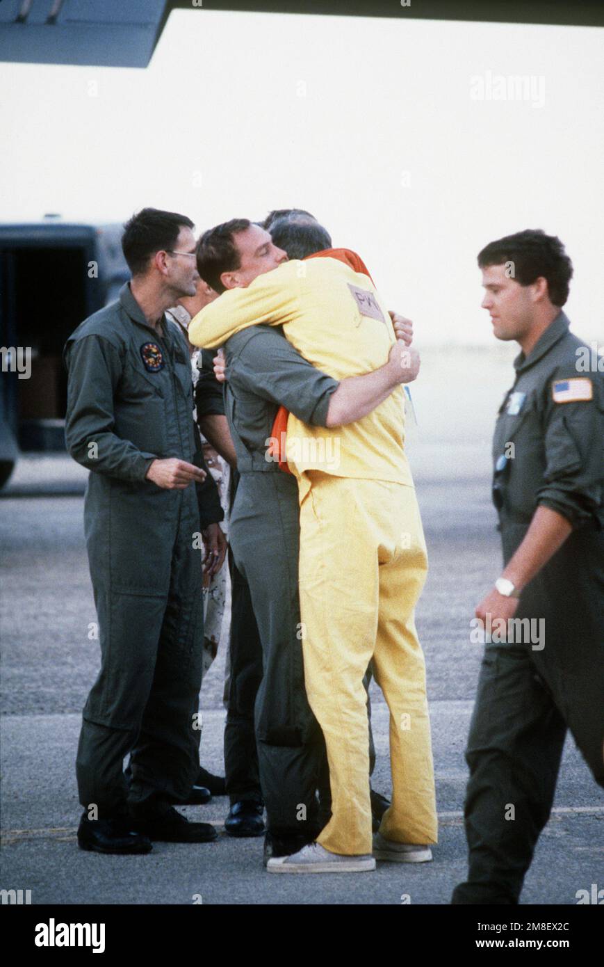 A former prisoner of war is greeted by fellow crew members after his ...