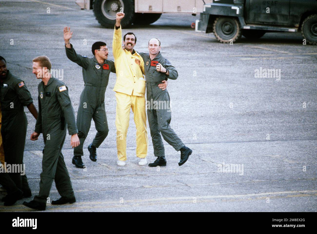 A former prisoner of war is greeted by fellow crew members after his ...