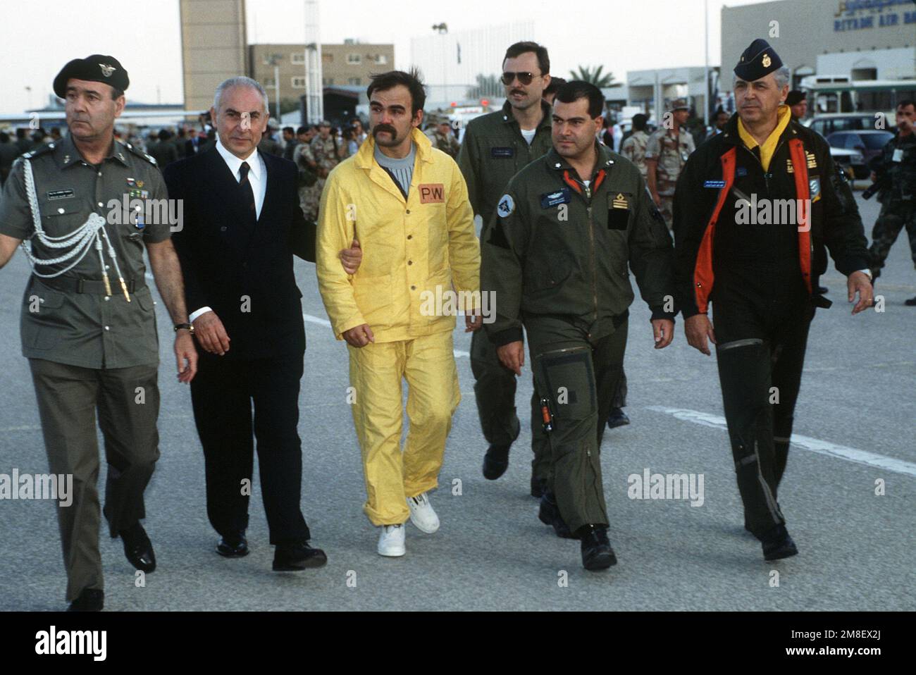 A former prisoner of war is greeted by fellow crew members after his ...