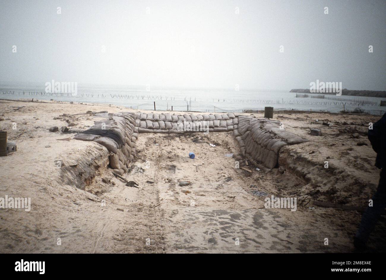 A beachfront emplacement for an Iraqi tank serves as a reminder of the ...