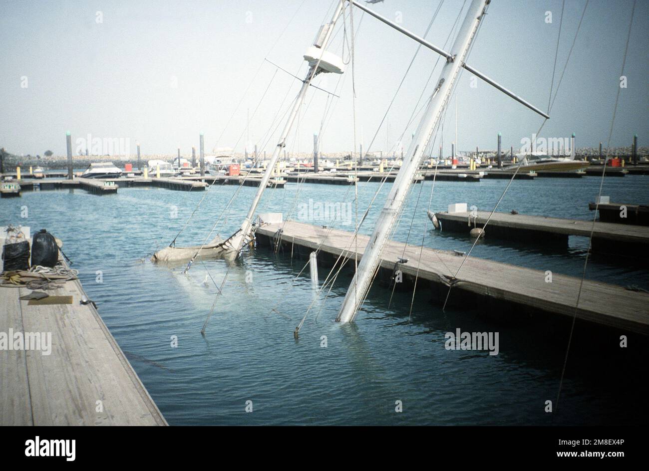 A Kuwaiti boat is sunken in the harbor in Kuwait City in the aftermath ...