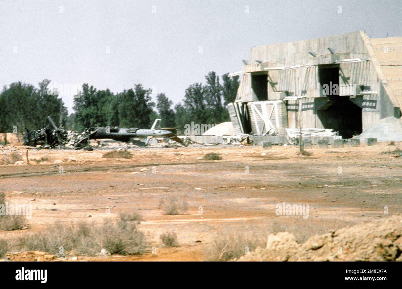 A view of an Iraqi helicopter and hangar destroyed by Coalition bombing ...