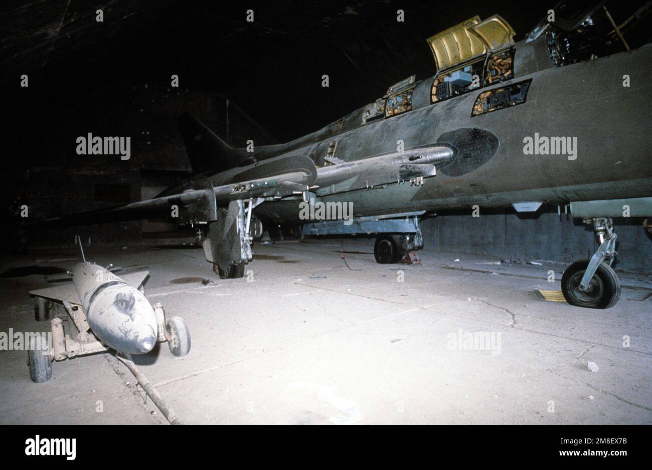 A view of an Iraqi Su-22 aircraft in a hangar damaged by Coalition air ...