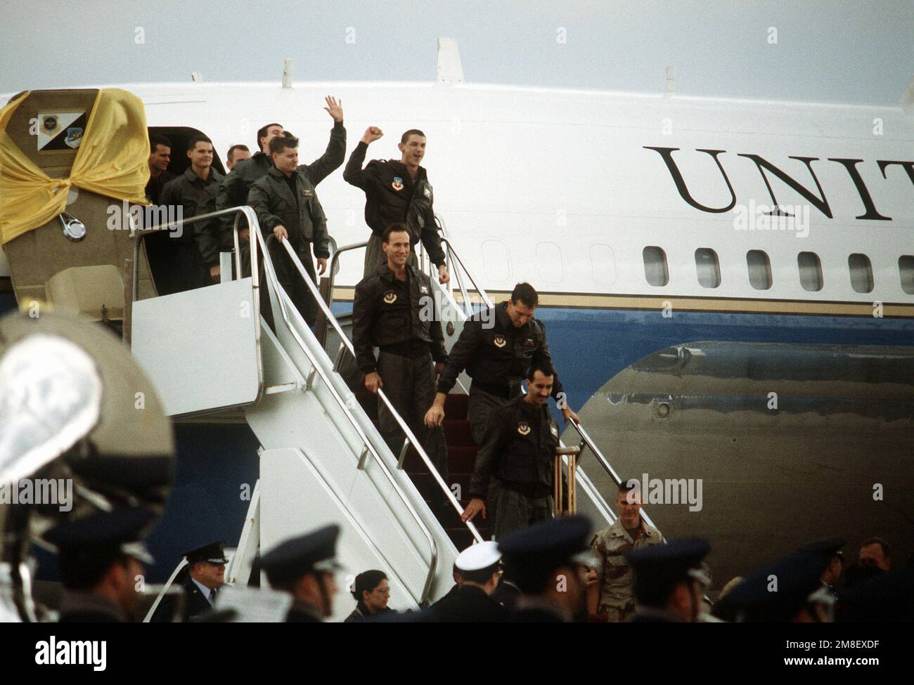 Former prisoners of war wave to the crowd gathered to welcome them upon ...
