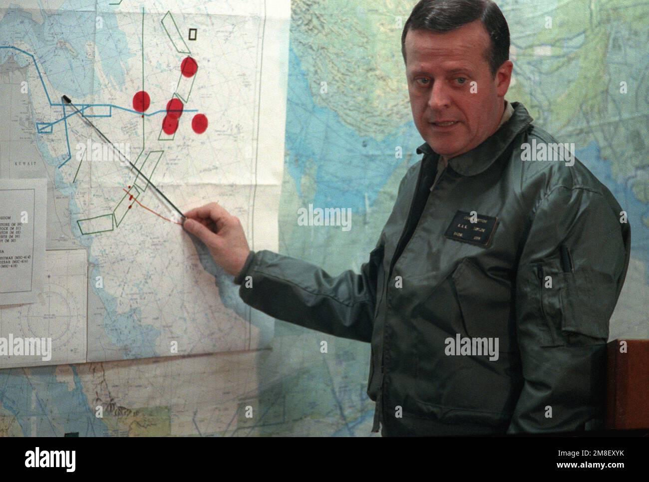 Rear Adm. Raynor A.K. Taylor, commander, Middle East Force, points out ...