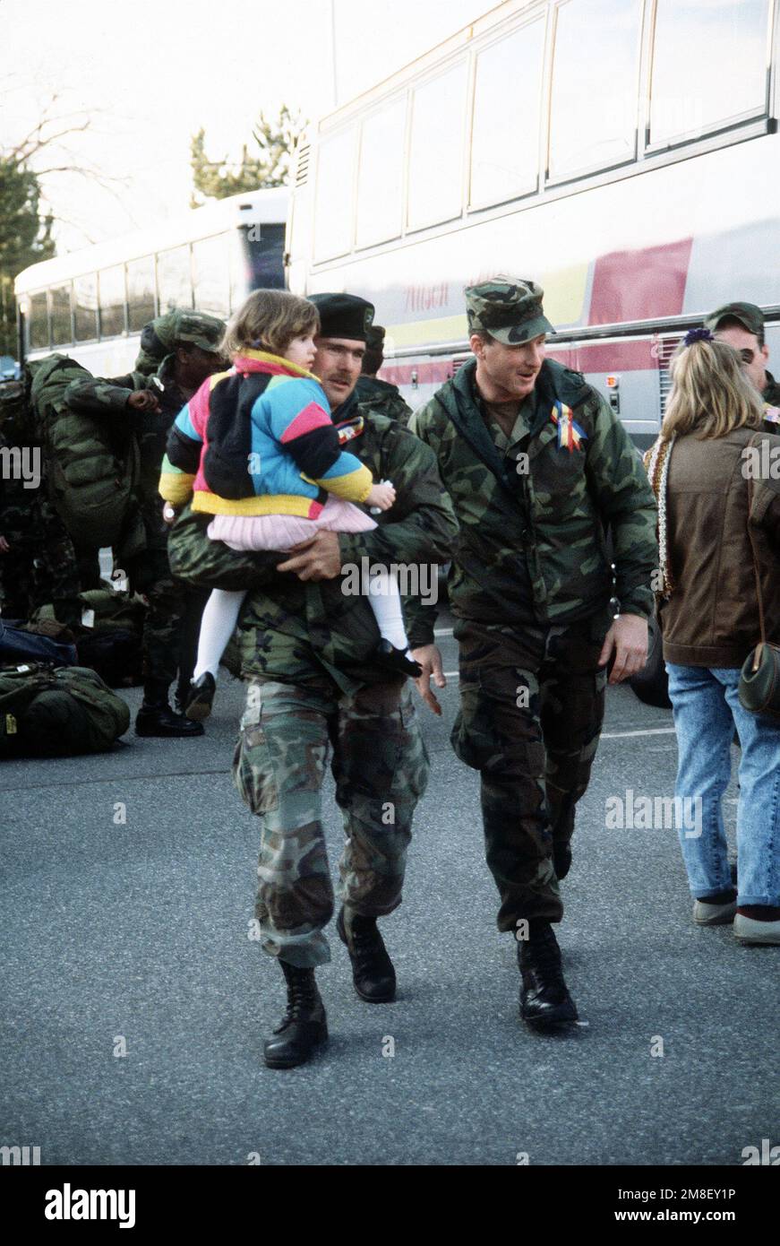 A member of the 10th Special Forces Group (Airborne) holds his daughter ...