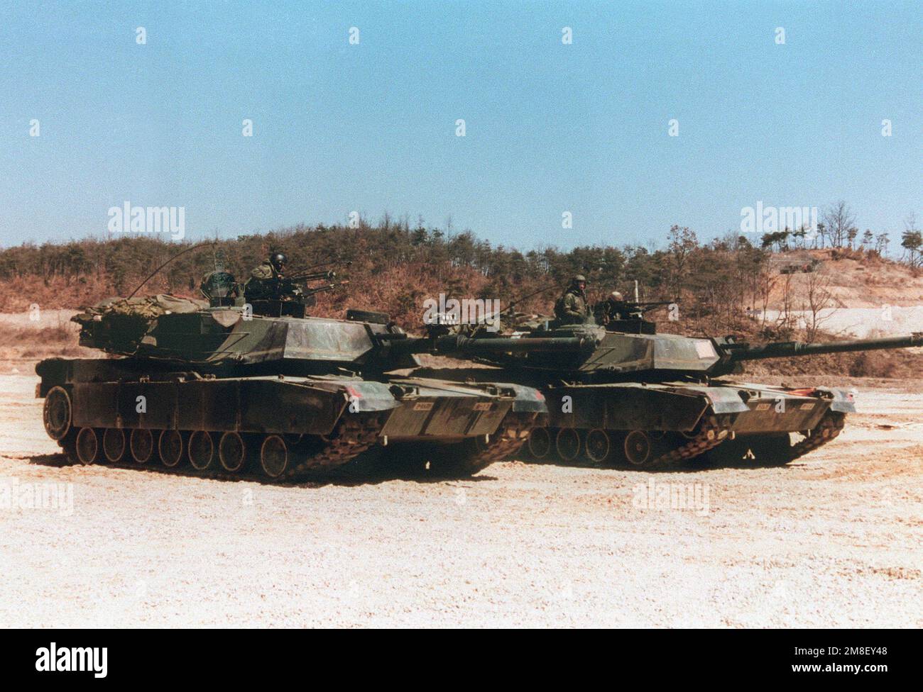 Right side view of two M1A1 tanks during training maneuvers. Subject ...